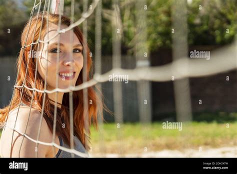 A Gorgeous Redhead Fitness Model Preparing To Play Volleyball Stock Photo Alamy