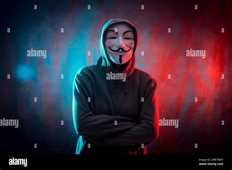 Hacker With Anonymous Mask With Arms Crossed Red And Blue Background Stock Photo Alamy