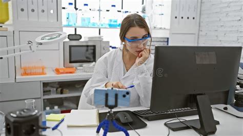 A Focused Caucasian Woman Scientist Analyzes Data On A Computer In A Laboratory Setting Stock