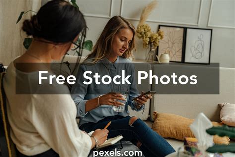 A Person Passing Something To Another Office Setting Photos Download