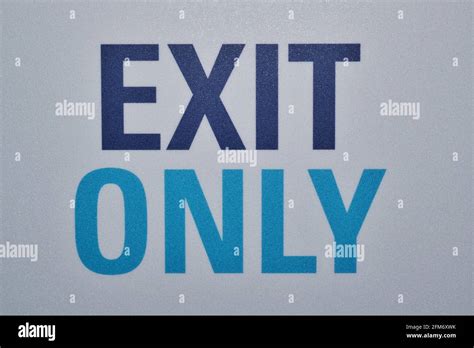 Exit Only Sign Blue Capital English Lettering On White Background Closeup And Centered Image