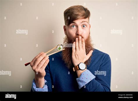 Redhead Irish Man With Beard Eating Green Maki Sushi Using Chopsticks