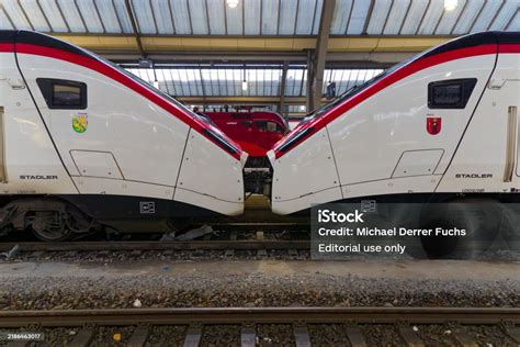 눈 내리는 가을날 스위스 취리히 시의 기차역에서 문장이 새겨진 두 개의 연결된 흰색 및 빨간색 열차의 측면 모습 0명에 대한 스톡 사진 및 기타 이미지 Istock