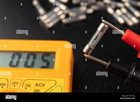 Checking Glass Fuses Using The Meter Simple Electrical Work In A Home Workshop Dark Background