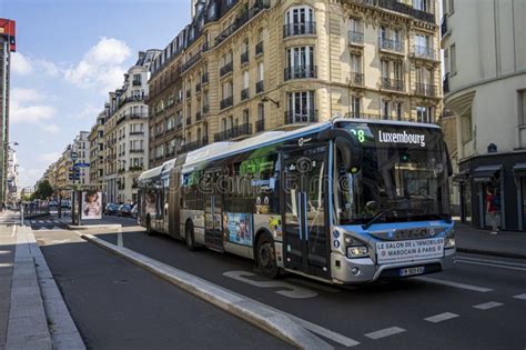 An Extended Bus Running In The Narrow Street Editorial Stock Image