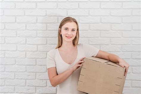 Premium Photo Pretty Woman Holding Cardboard Box Delivering A Parcel