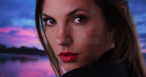 Close Up Of Beautiful Lady Looking Over Shoulder With Beach Sunset In