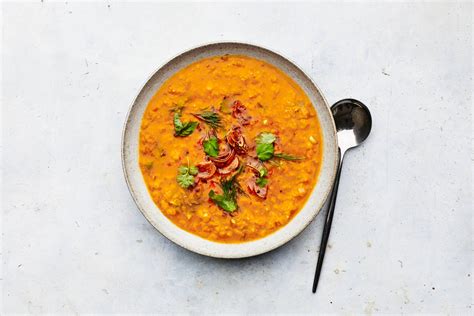 Download Caption Savory Red Lentil Soup Garnished With Spice Wallpaper