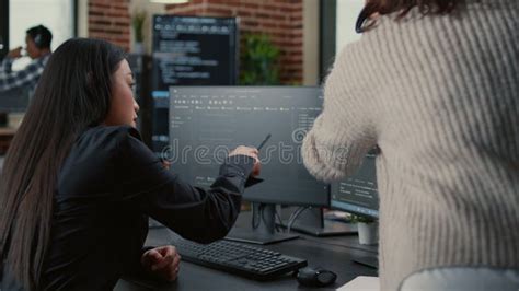 Programer Pointing Pencil At Computer Screen With Software Compiling Code Explaining Source
