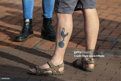 A Tottenham Tattoo Of A Cockerel On The Leg Of A Man Wearing Sandals