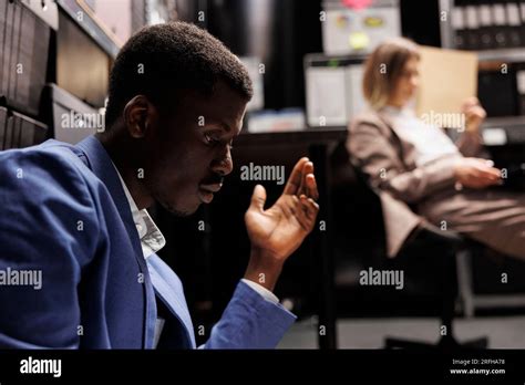 Tired Diverse Colleagues Working Overtime In Arhive Room Analyzing