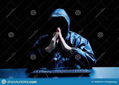 Anonymous Computer Hacker In White Mask And Hoodie Obscured Dark Face
