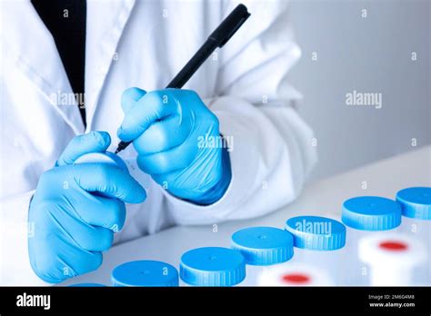 Close Up Left Handed Woman Scientist Labeling Samples With Blue Gloves