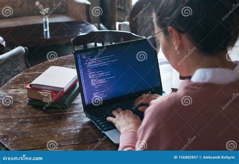 Hacking System Excited Girl With Dark Hair And In Pink Sweater And Glasses Writes Code On A