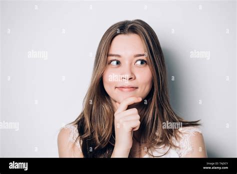 Beautiful Woman Looking Aside Holding Hand Under Chin Indenting To