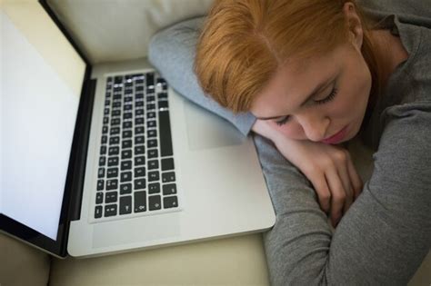 Premium Photo Redhead Sleeping On The Couch With Her Laptop