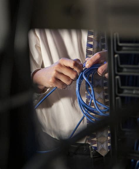 Closeup Of A A Computer Technician Holding An Ethernet Cable Stock