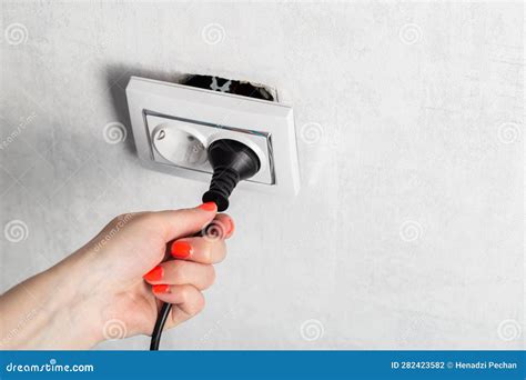 The Girl Incorrectly Removes The Electric Plug From The Socket And Breaks The Socket Danger Of