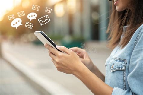 Woman Using Smartphone Outdoors With Chat Icons Representing A Connected Modern Digital