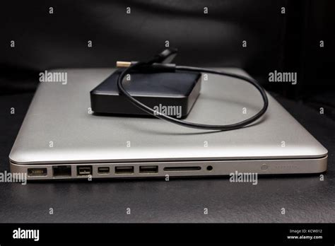 Silver Laptop With External Hard Drive On Dark Black Background Stock Photo Alamy