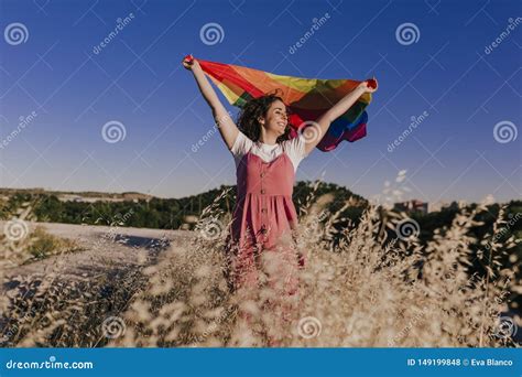 Woman Holding The Gay Rainbow Flag At Sunset Happiness Freedom And Love Concept For Same Sex