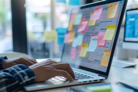 business developer using kanban board framework on laptop computer agile software development