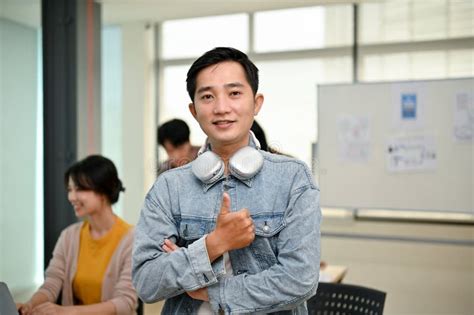 A Smart Asian Male Developer Showing His Thumb Up While Standing In The