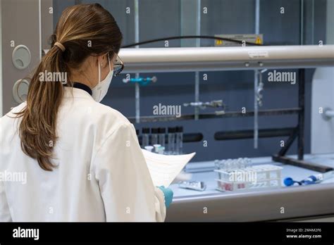 Female Scientist With An Experimental Protocol In Her Hand While Planning A Scientific