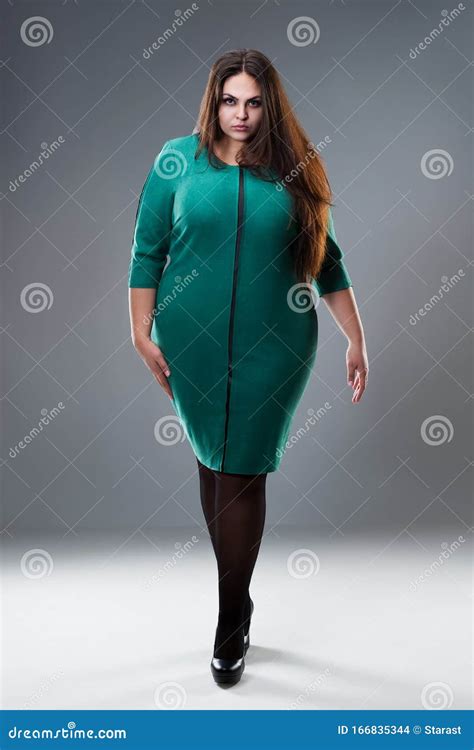 Plus Size Model In Green Dress Fat Woman With Long Hair On Gray