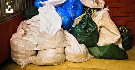 A Pile Of Garbage Sitting Next To A Brick Wall Photo Free Garbage