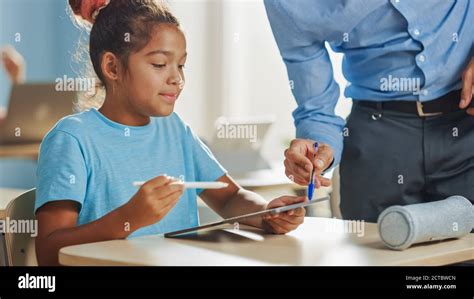 Elementary School Computer Science Class Smart Girl Uses Digital Tablet Computer Friendly