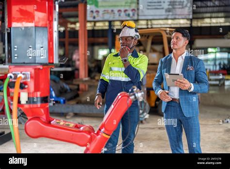 Engineer Customer Service Explain Introduction Of New Design Robotic Model To Buyer At Factory