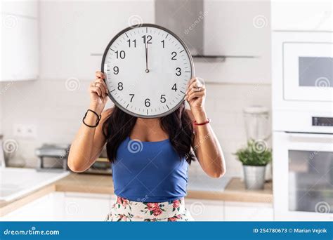 Woman Holds A Clock Showing One Minute To Twelve In Fron Of Her Face Stock Image Image Of Hour