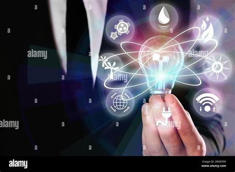 Energy Efficiency Concept Man Holding Light Bulb Surrounded By Icons Closeup Stock Photo Alamy