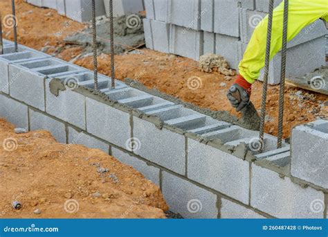 Bricklayers Are Laying Concrete Blocks In A Wall In Order To Construct
