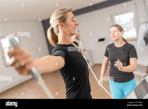 Smiling Female Client Holding Body Composition Balance Scale Analysis Handles For Inbody Test