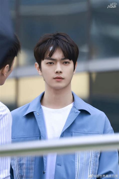 The Young Man Is Wearing A Blue Shirt