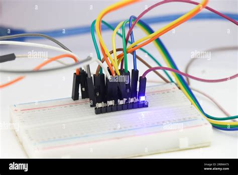 Group Of Smd Led On A Breadboard Connected With Jumper Wires And Emitting A Blue Light Stock