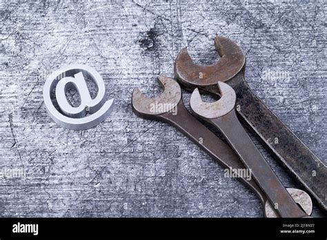 The Photo Shows Various Rusty Wrenches On A Gray Background With A Add Sysmbol Stock Photo Alamy