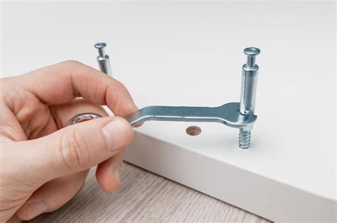 Premium Photo Male Hand With Spanner And Confirmatory Screeds As A