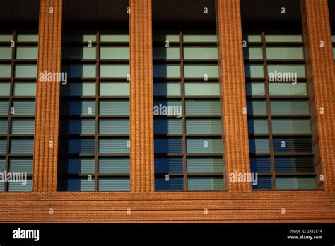 Close Up Detail Of Modern Orange Brick Building Facade With Blue Tinted