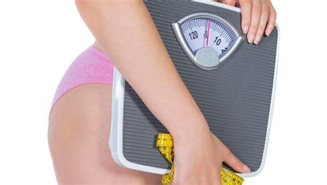 Premium Photo Female Model Holding Scale And Measuring Tape Over White Background