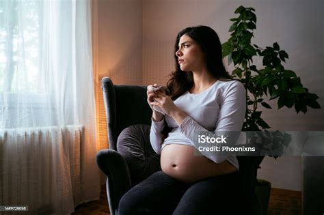 Sad Depressed Pregnant Woman Sitting Alone In Dark Room Worried Stock