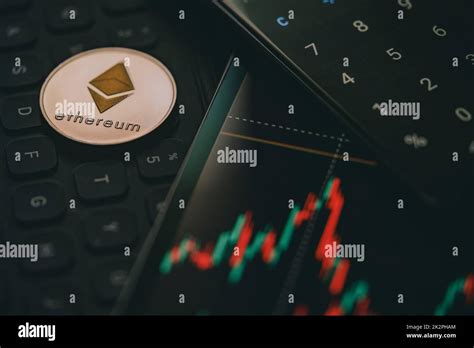 Ethereum Cryptocurrency Coin Near A Monitor With Candle Stick Graph Chart And Digital Calculator Ethereum Cryptocurrency Coin Near A Monitor With Candle Stick Graph Chart And Digital Calculator