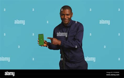Portrait Of Upbeat Security Staff Member Showing Green Screen Smartphone Cheerful Patrolling