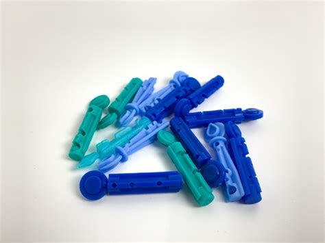 Premium Photo Sterile Lancet Needle For Diabetes Examination On White