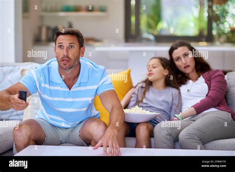 Hes Really Getting Into The Game A Man Watching Sports On The Tv While