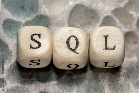 The Word Sql Structured Query Language Lined With Wooden Blocks On A Metal Forged Textural