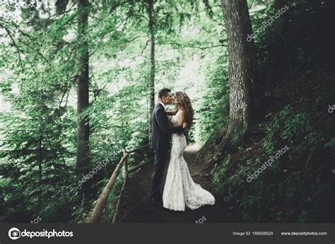 Romantic Fairytale Happy Newlywed Couple Hugging And Kissing In A