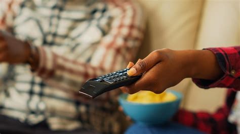 Free Photo Young Girlfriend Using Tv Remote Control To Watch Film